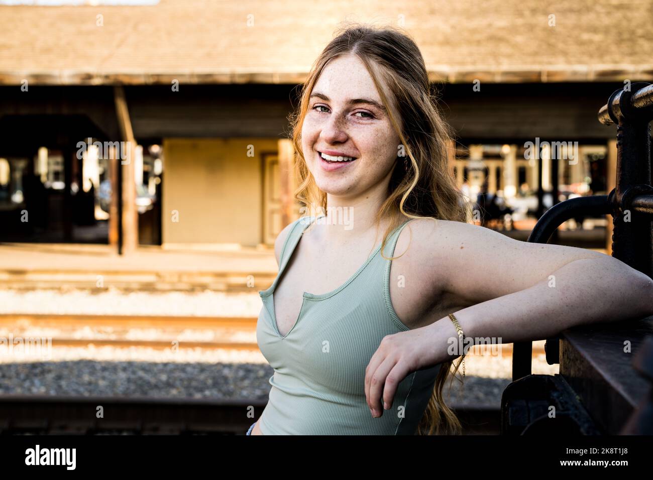 Teenage Girl in Trainyard Standing in Front of Old Black Steam Engine ...