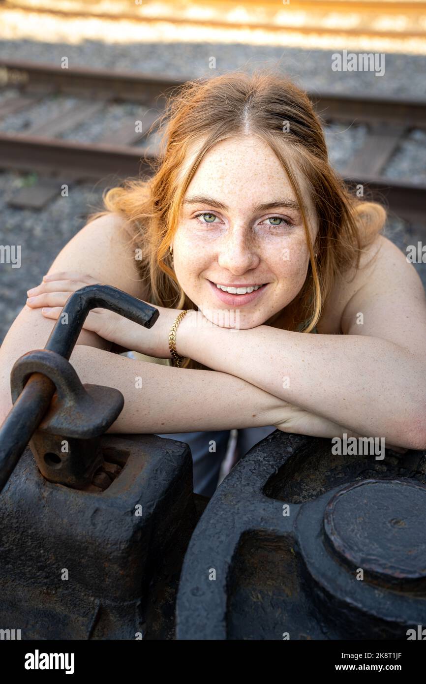 Teenage Girl in Trainyard Standing in Front of Old Black Steam Engine ...