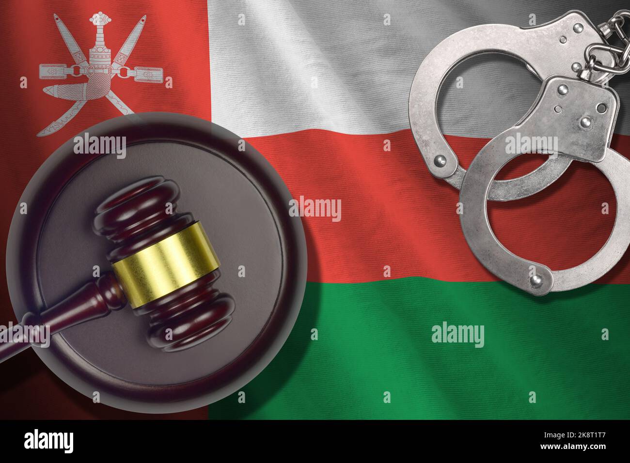 Oman flag with judge mallet and handcuffs in dark room. Concept of ...
