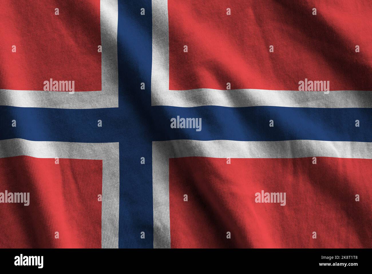 Norway flag with big folds waving close up under the studio light ...
