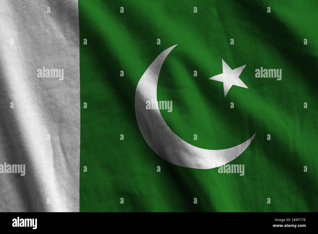 Pakistan flag with big folds waving close up under the studio light ...