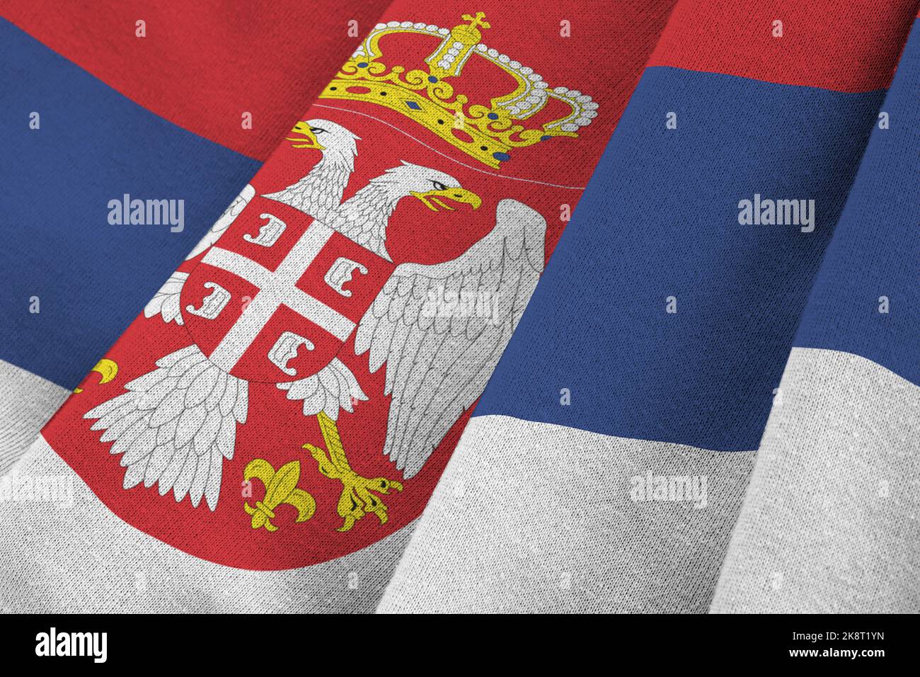 Serbia flag with big folds waving close up under the studio light ...