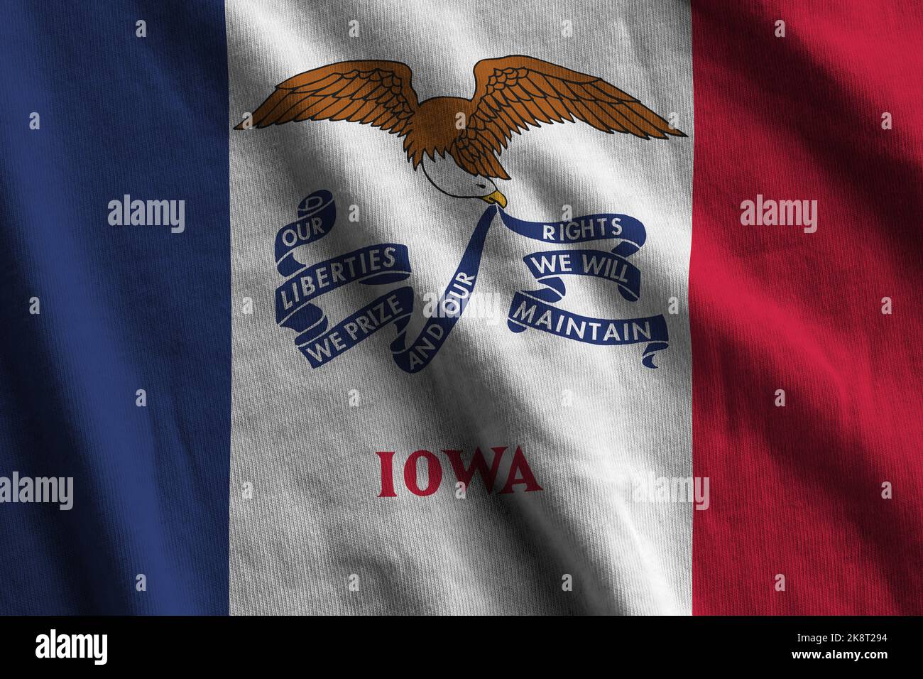 Iowa US state flag with big folds waving close up under the studio ...