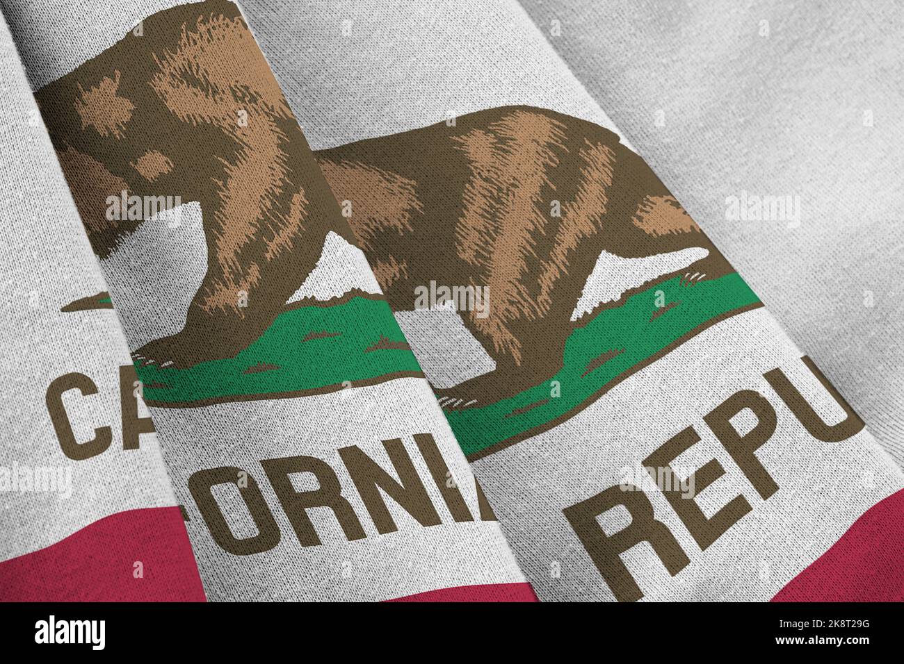 California US state flag with big folds waving close up under the ...