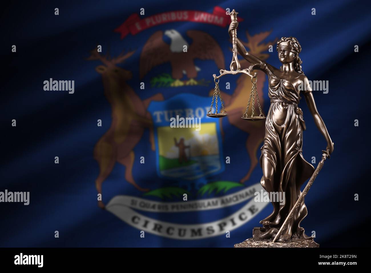 Michigan US state flag with statue of lady justice and judicial scales ...