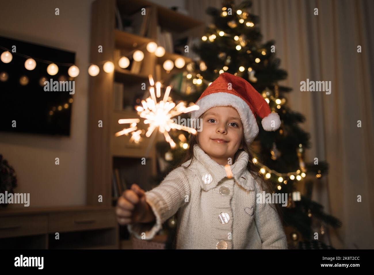 Close up view portrait of lovely cute little girl in warm knitted white ...