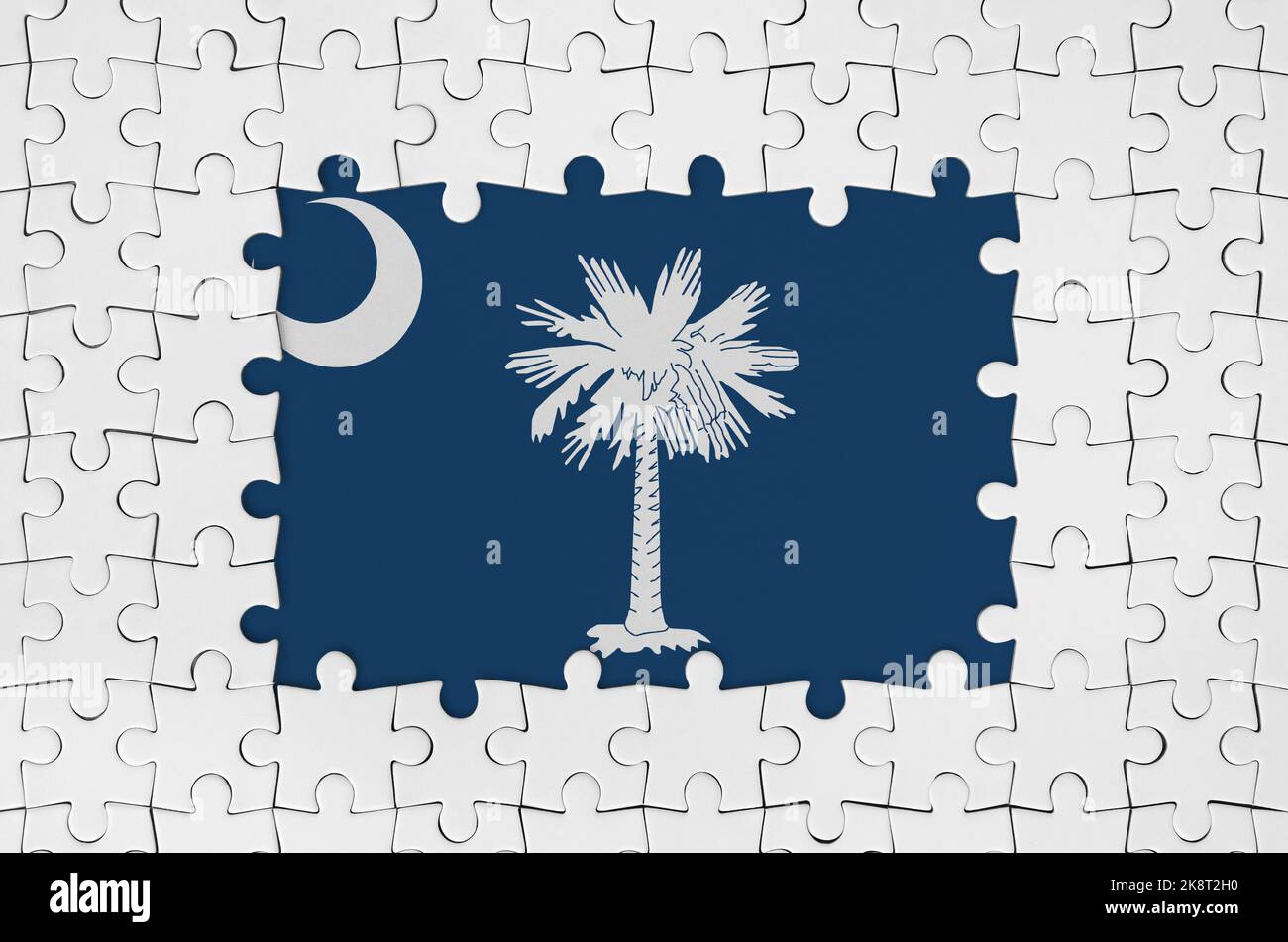 South Carolina US state flag in frame of white puzzle pieces with ...