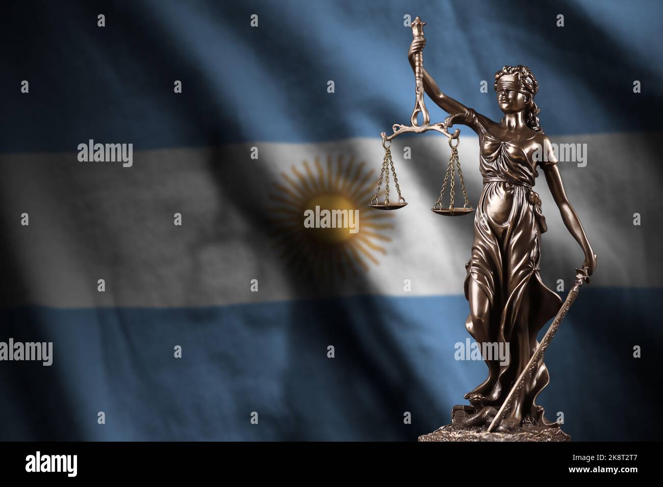 Argentina flag with statue of lady justice and judicial scales in dark ...