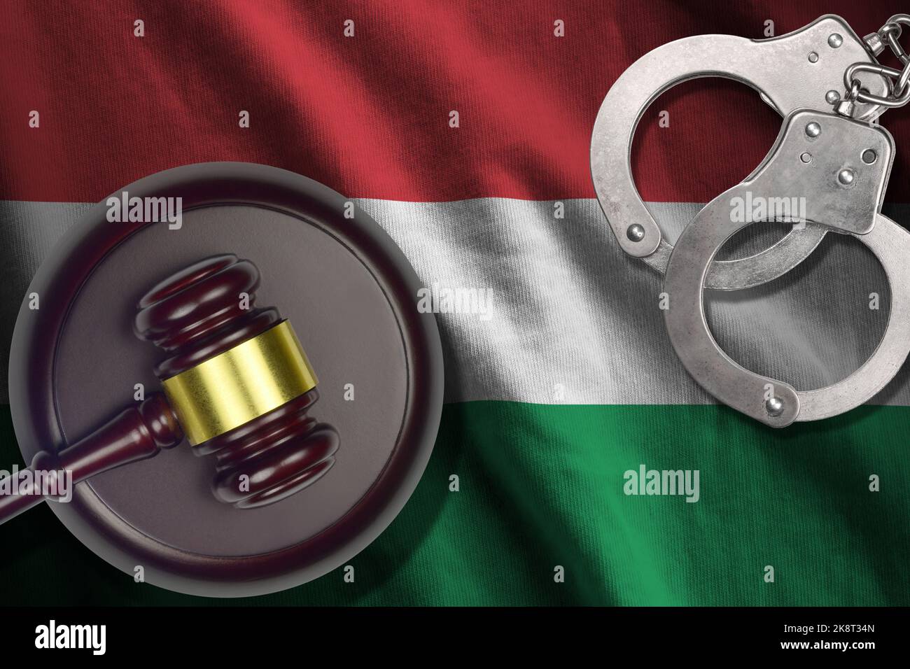 Hungary flag with judge mallet and handcuffs in dark room. Concept of ...