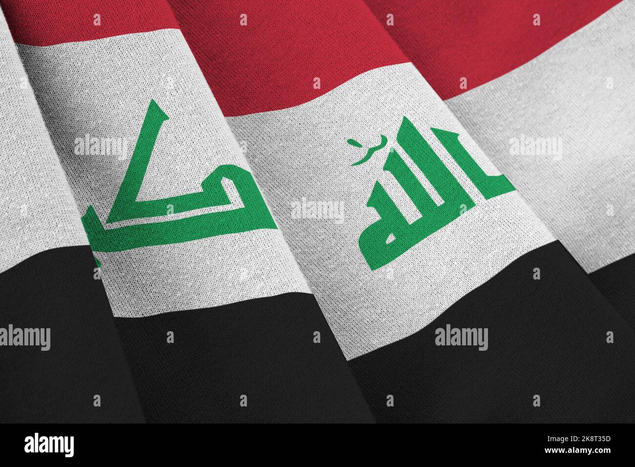 Iraq flag with big folds waving close up under the studio light indoors ...