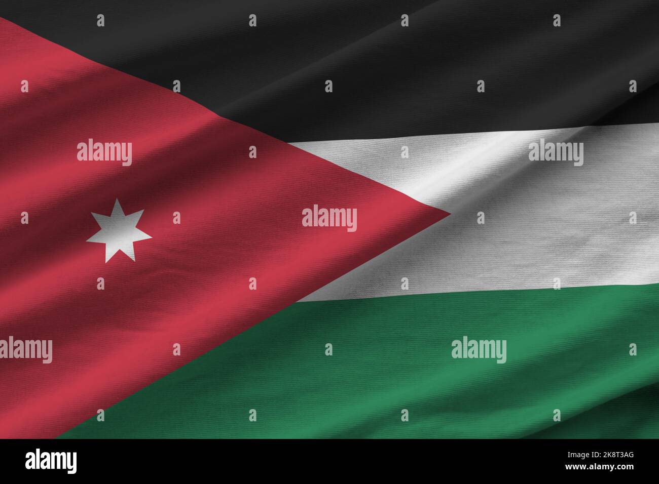 Jordan flag with big folds waving close up under the studio light ...