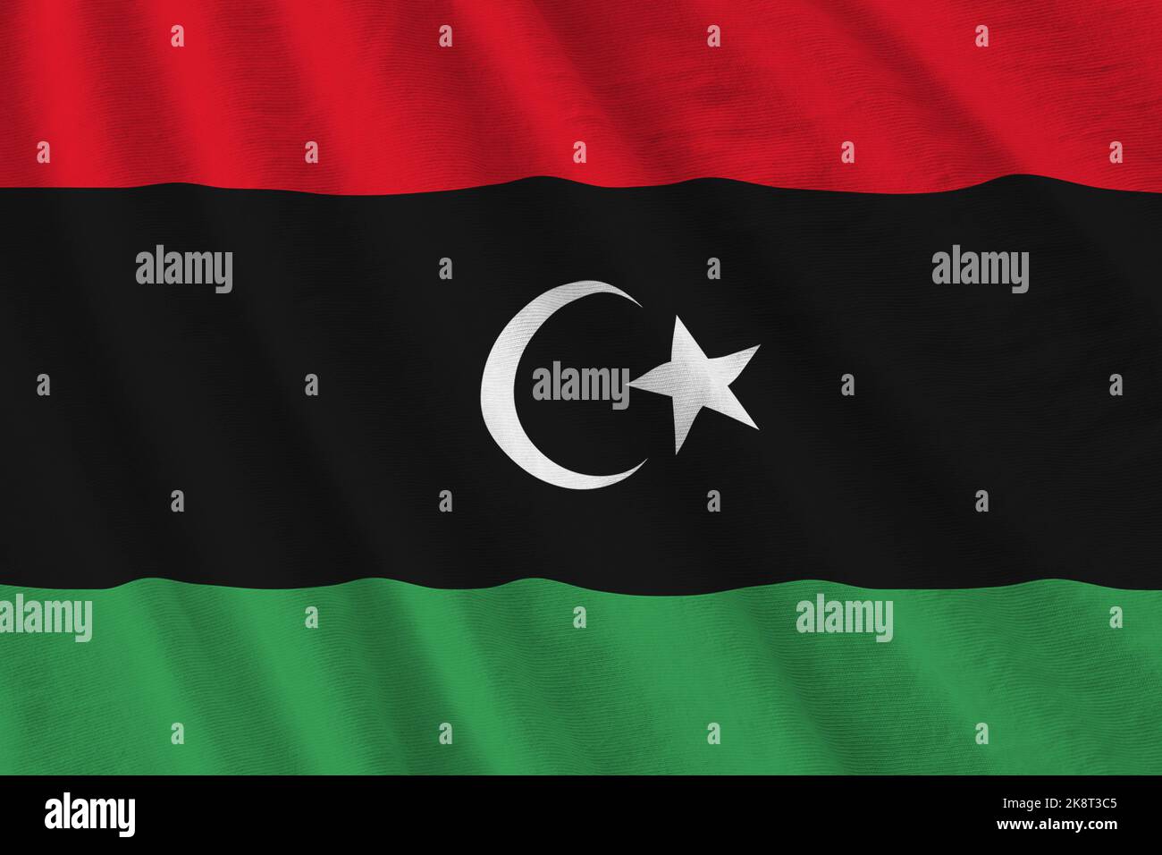 Libya flag with big folds waving close up under the studio light ...