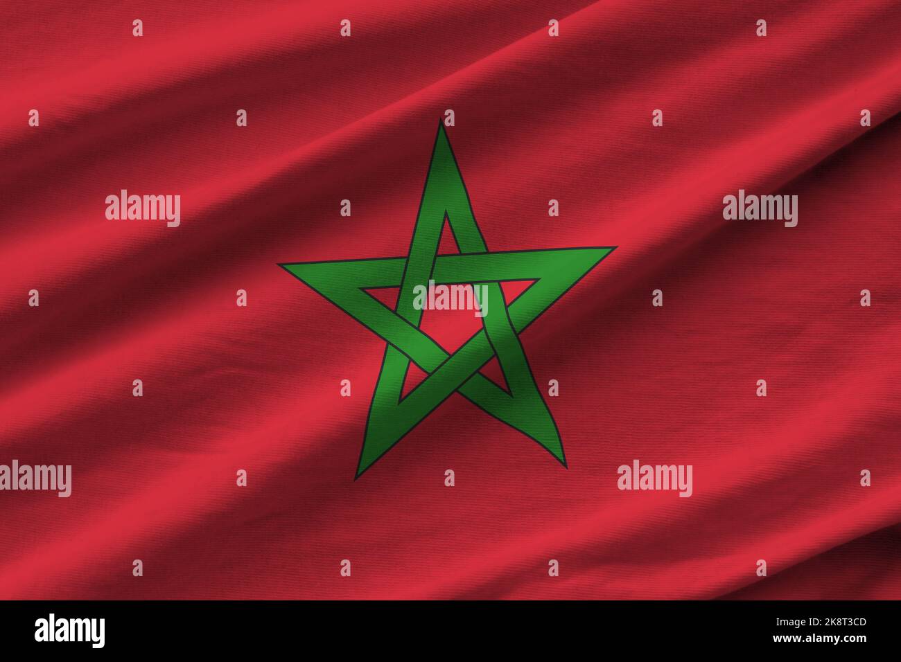 Morocco flag with big folds waving close up under the studio light ...