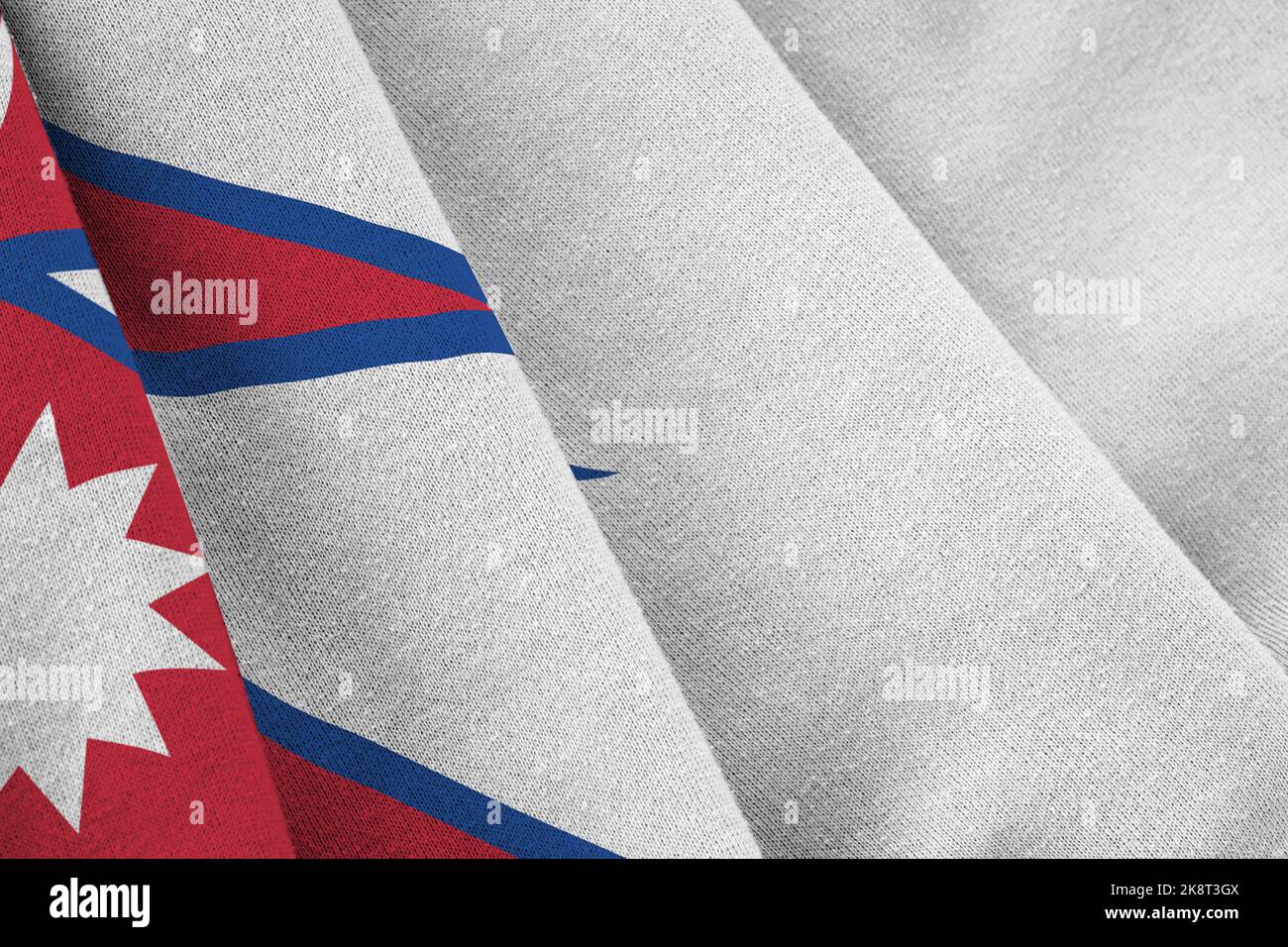 Nepal flag with big folds waving close up under the studio light ...