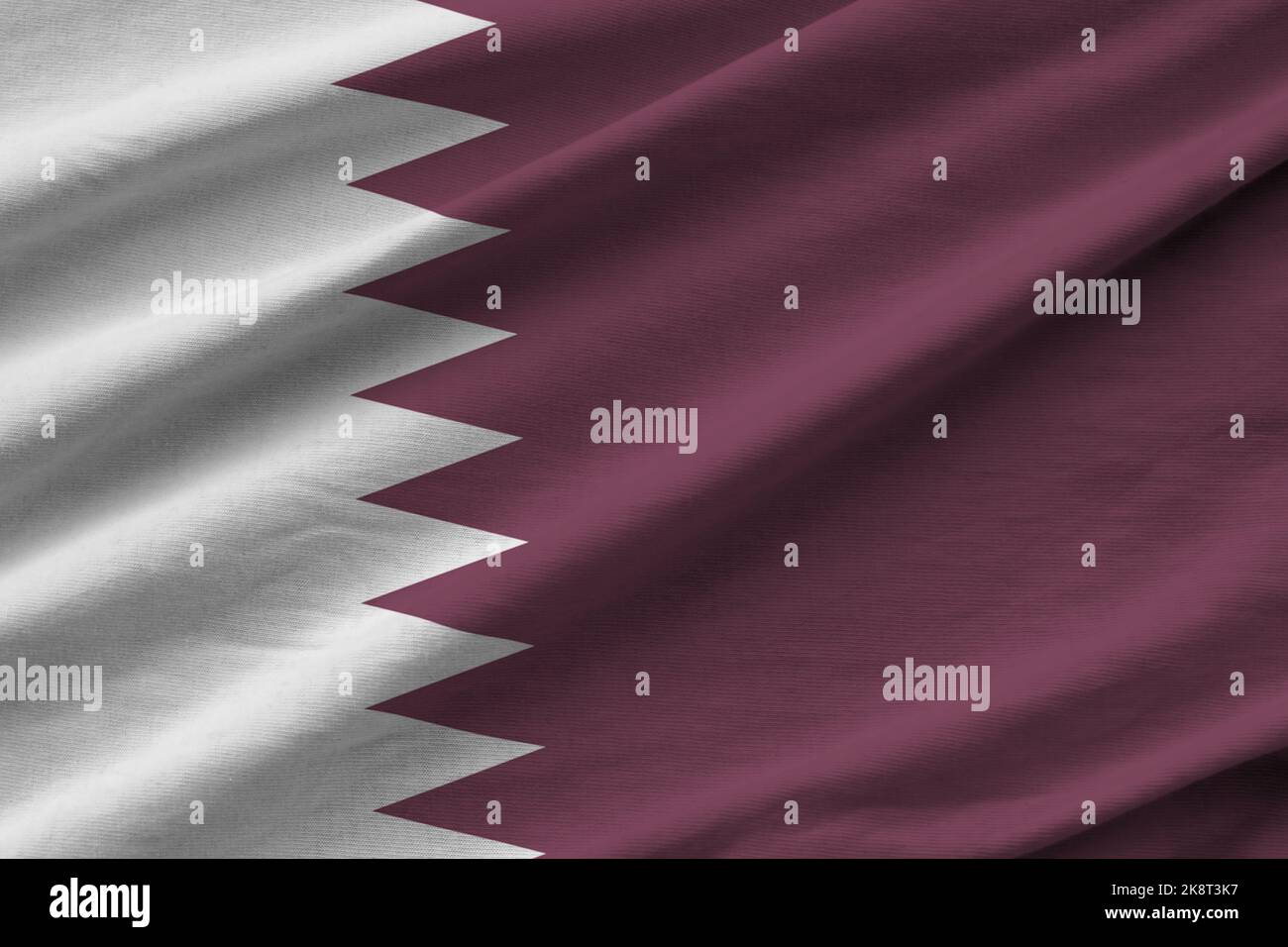 Qatar flag with big folds waving close up under the studio light ...