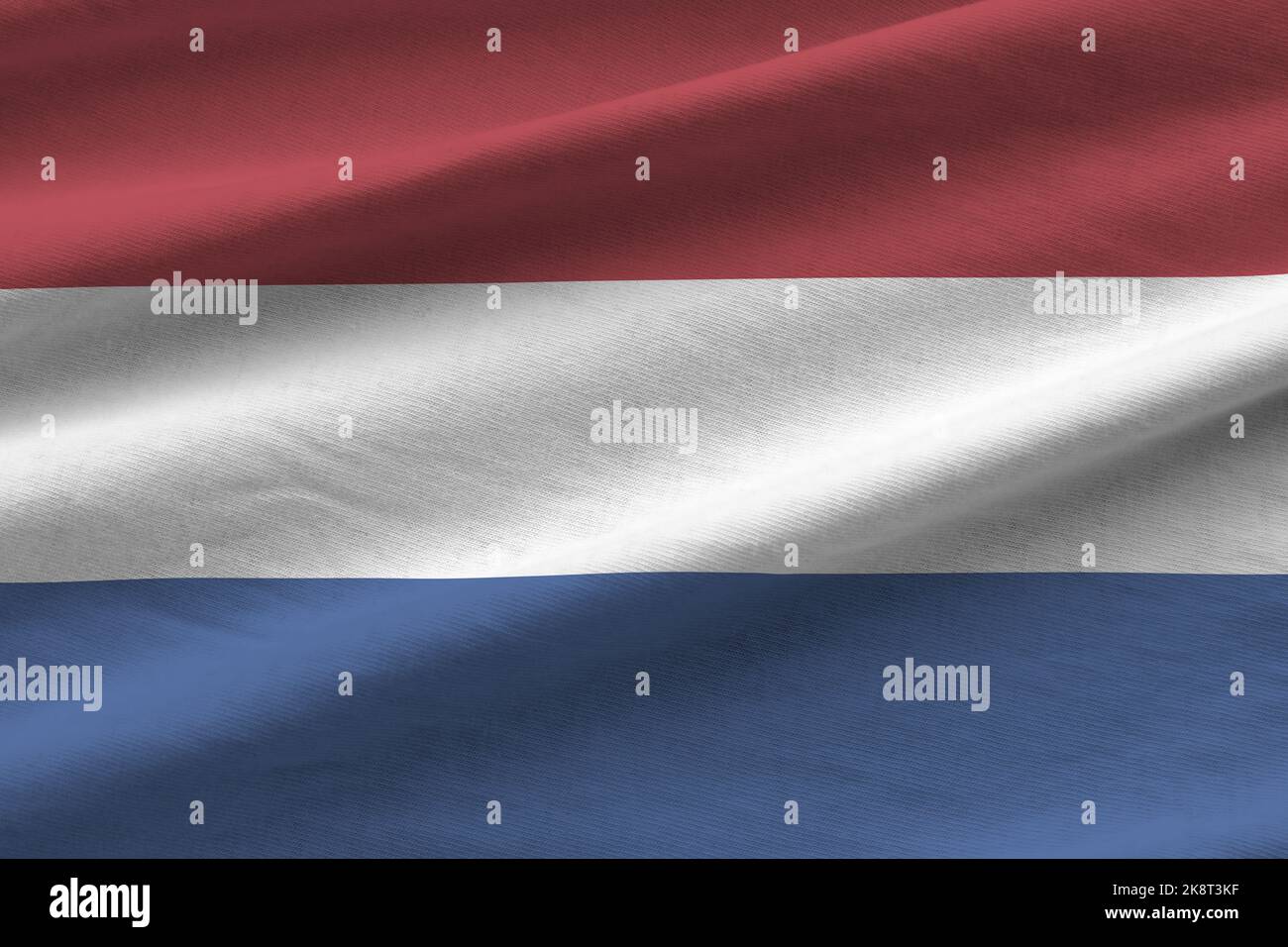 Netherlands flag with big folds waving close up under the studio light ...
