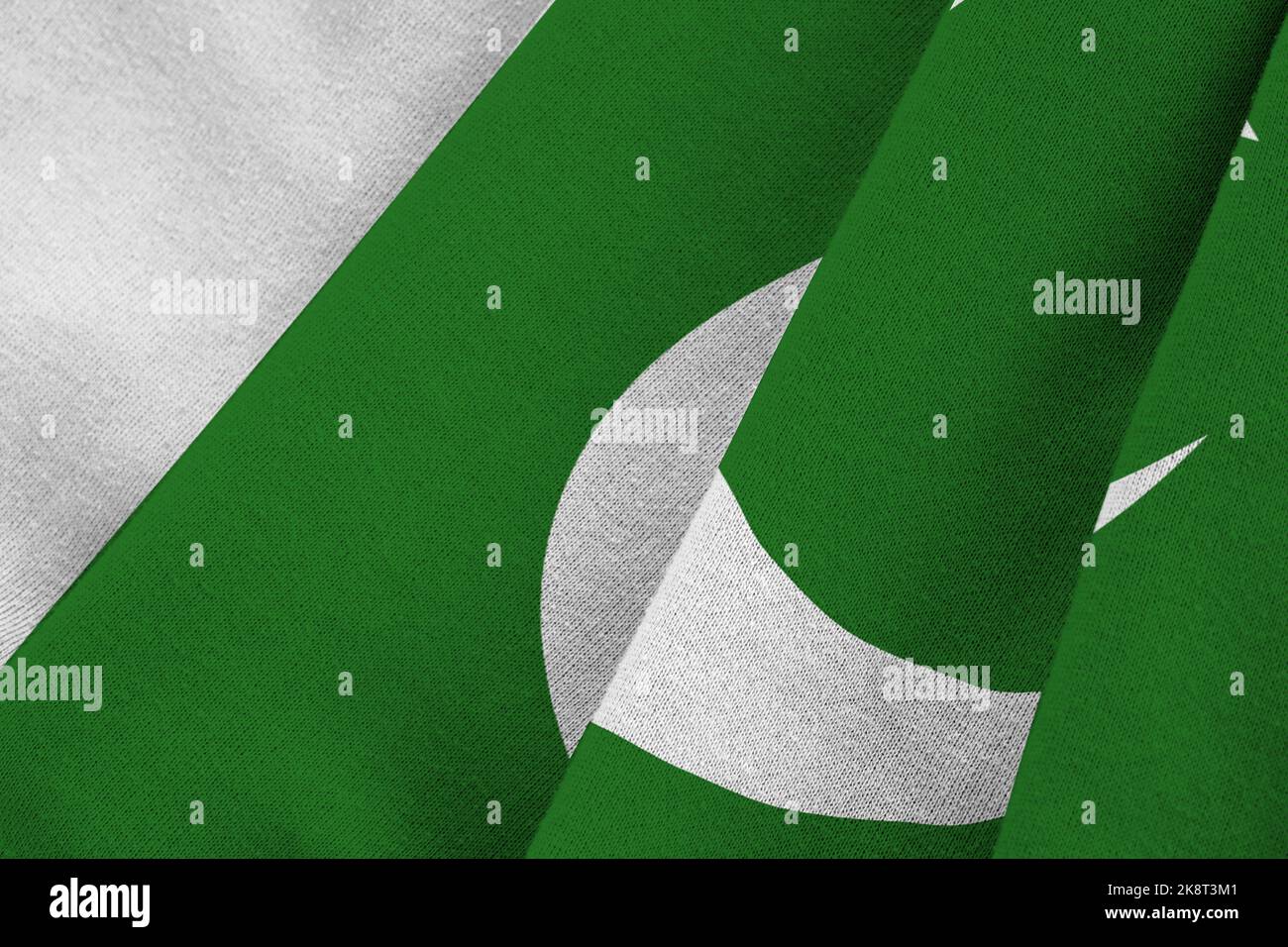 Pakistan flag with big folds waving close up under the studio light ...