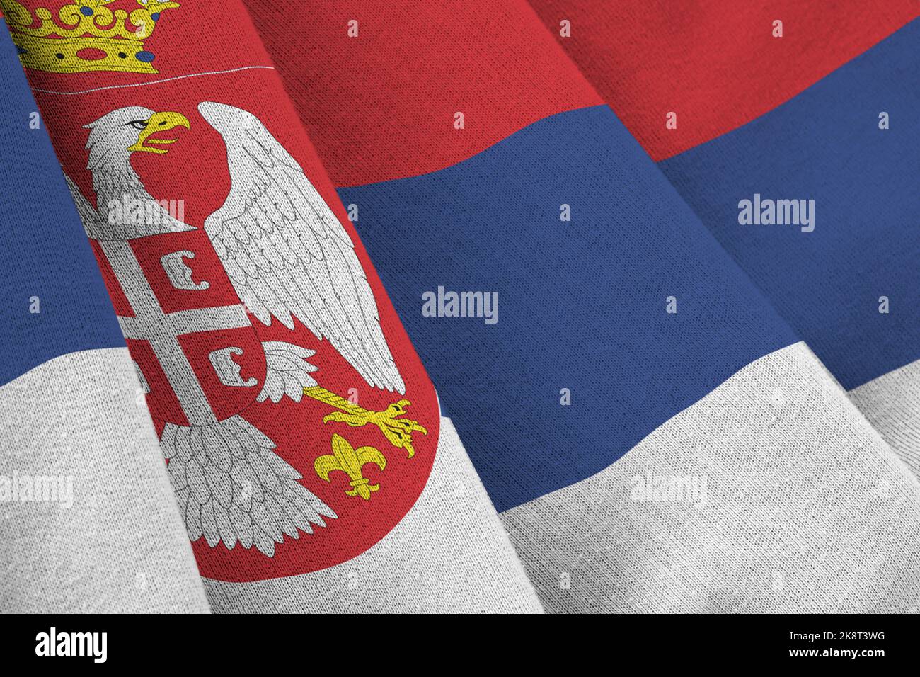 Serbia flag with big folds waving close up under the studio light ...