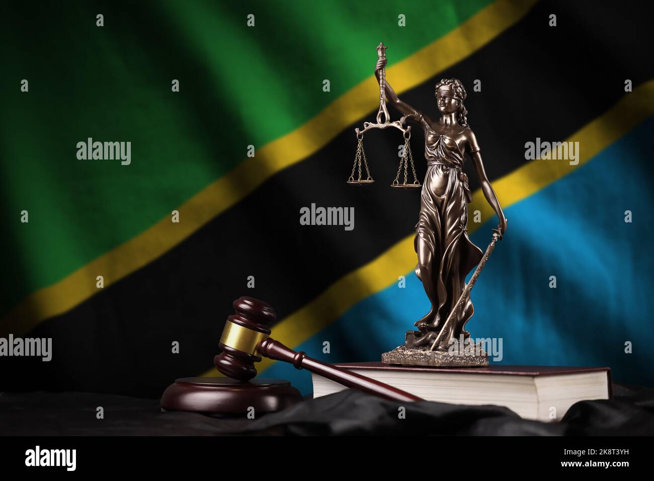 Tanzania flag with statue of lady justice, constitution and judge ...