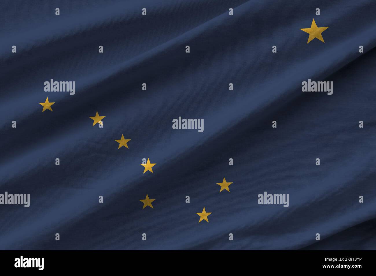 Alaska US state flag with big folds waving close up under the studio ...