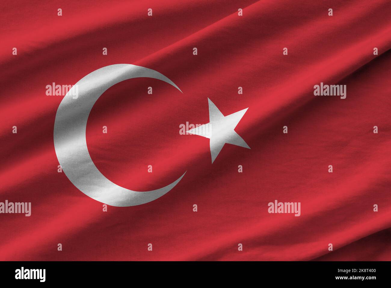 Turkey flag with big folds waving close up under the studio light ...