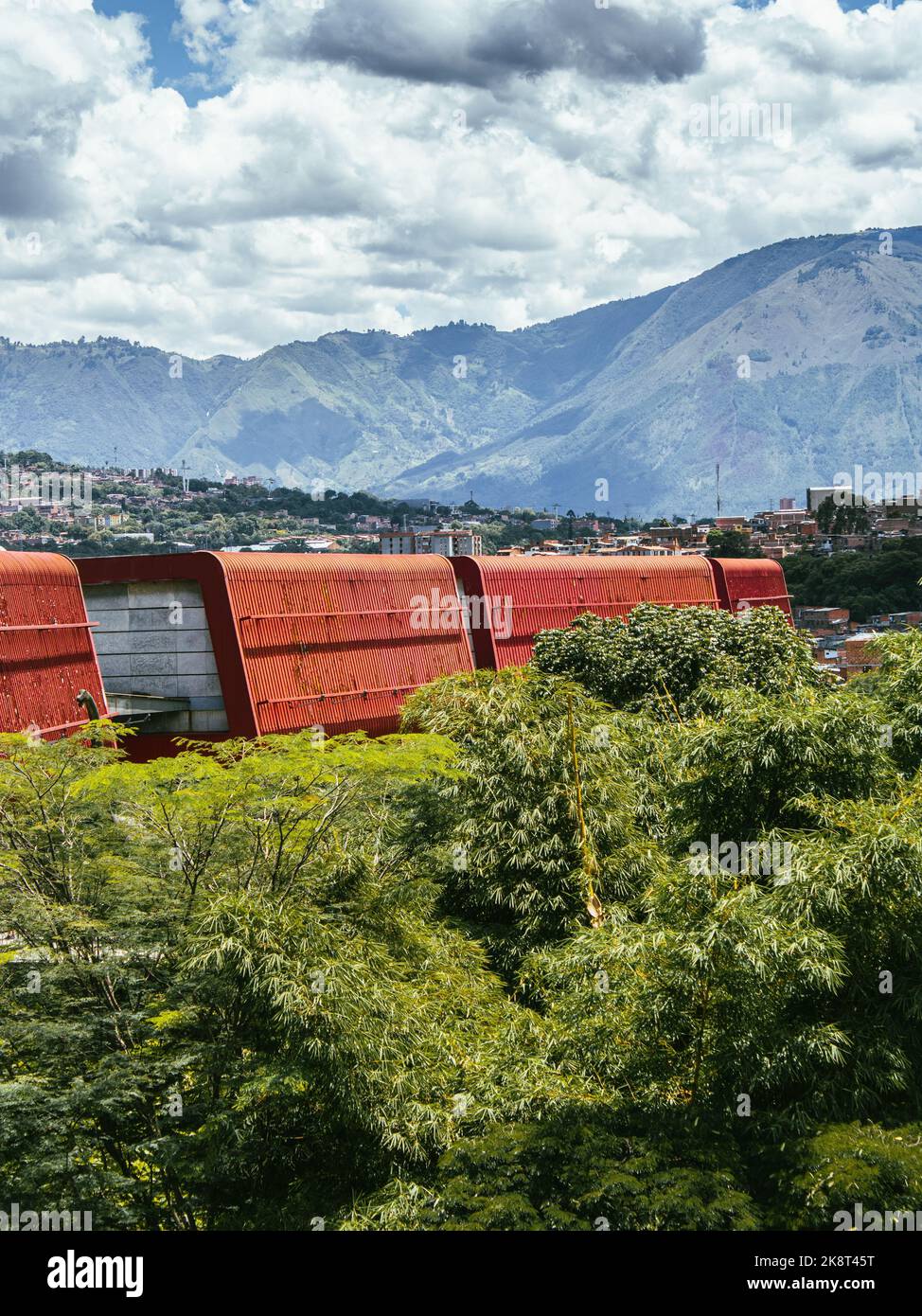 A vertical shot of the Parque Explora and the mountains of the city of ...