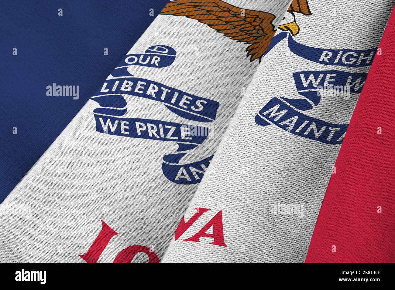 Iowa US state flag with big folds waving close up under the studio ...