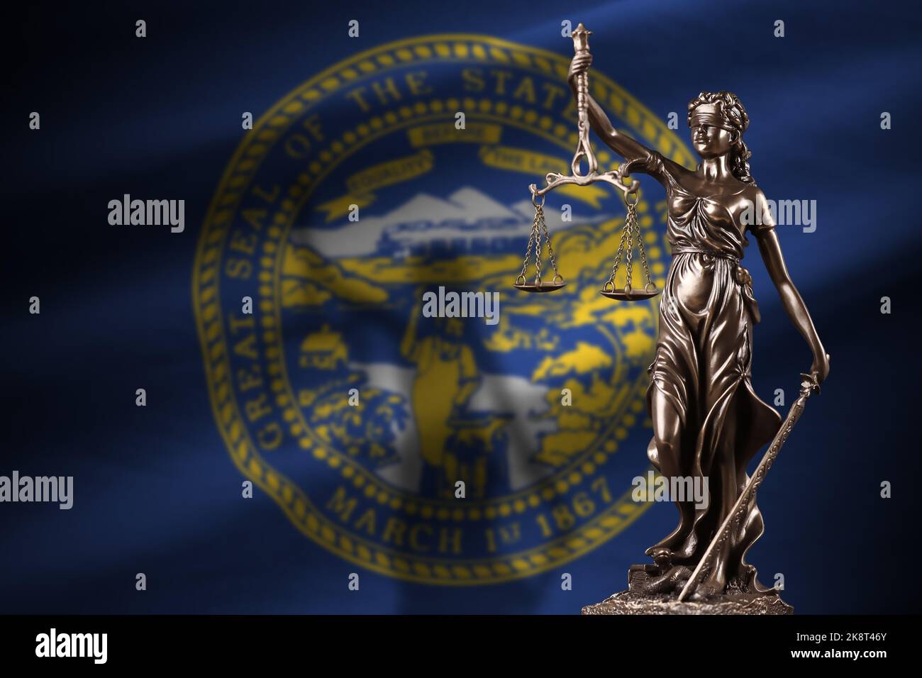 Nebraska US state flag with statue of lady justice and judicial scales ...