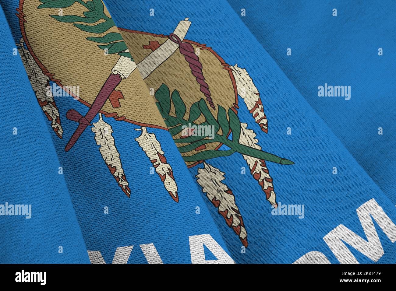 Oklahoma US state flag with big folds waving close up under the studio ...