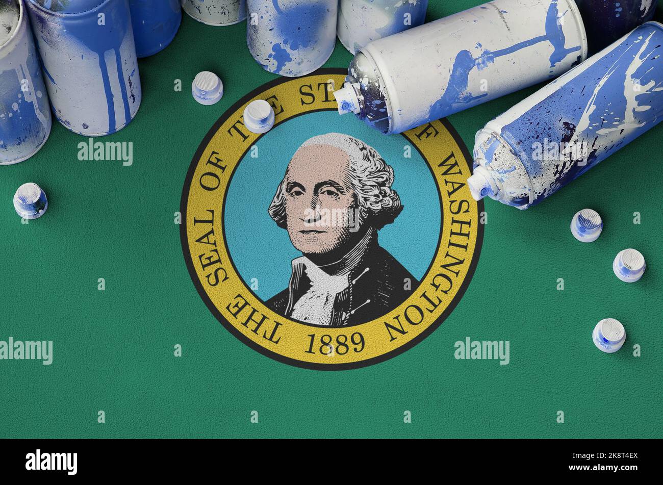 Washington US state flag and few used aerosol spray cans for graffiti ...