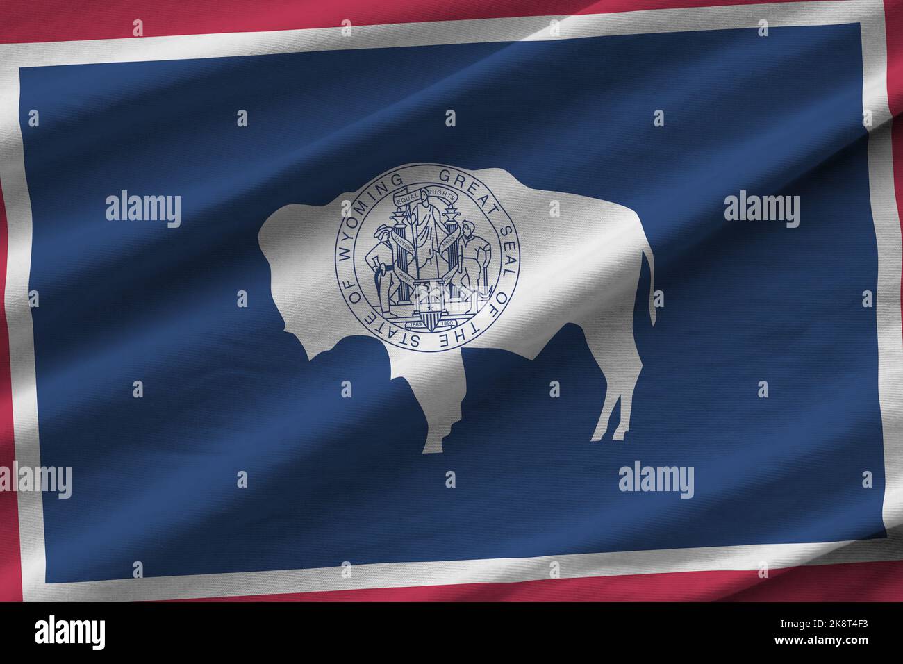 Wyoming US state flag with big folds waving close up under the studio ...