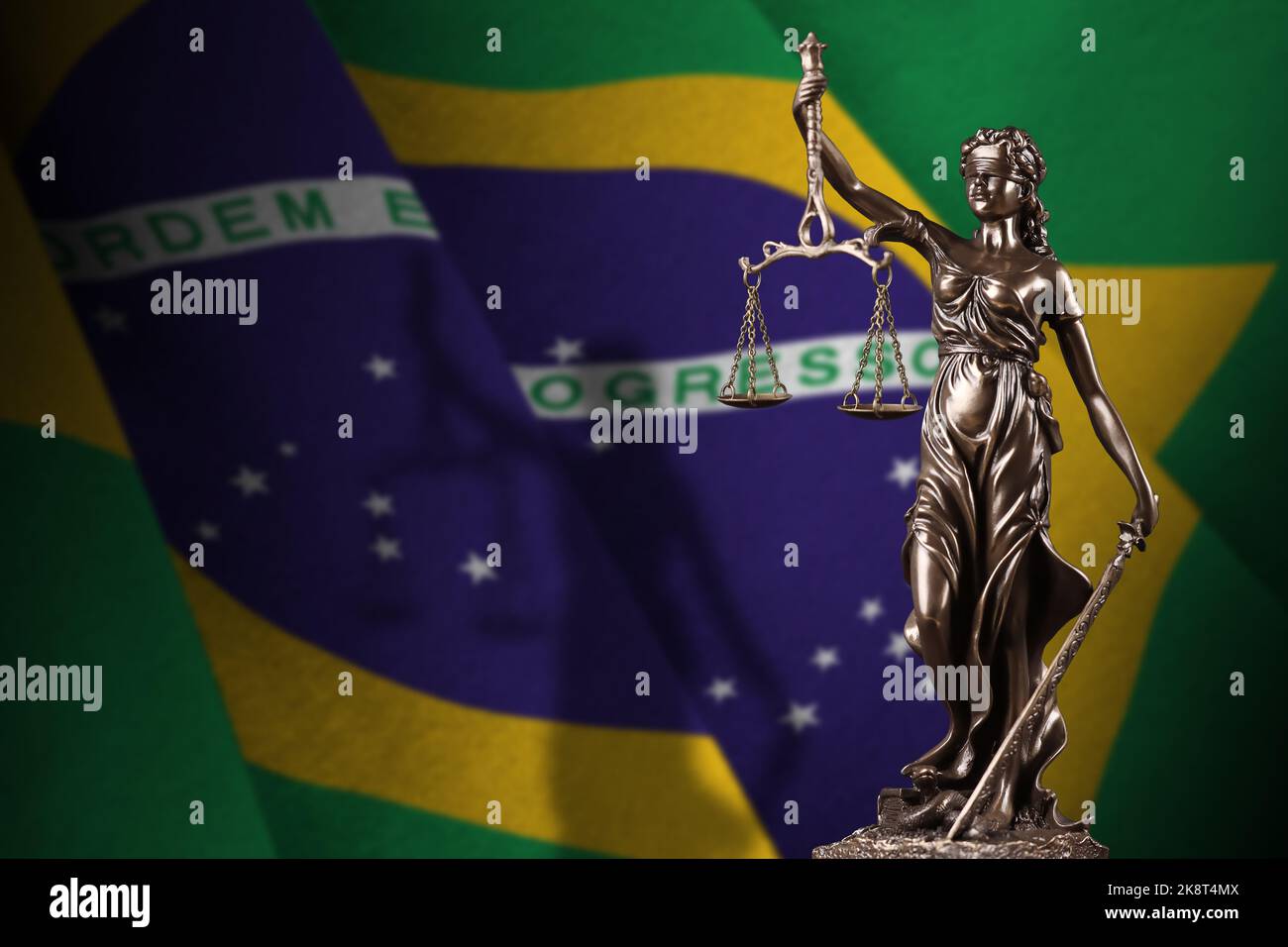 Brazil flag with statue of lady justice and judicial scales in dark ...