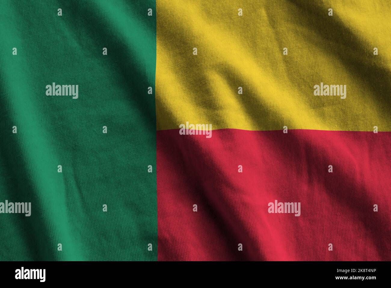 Benin flag with big folds waving close up under the studio light ...