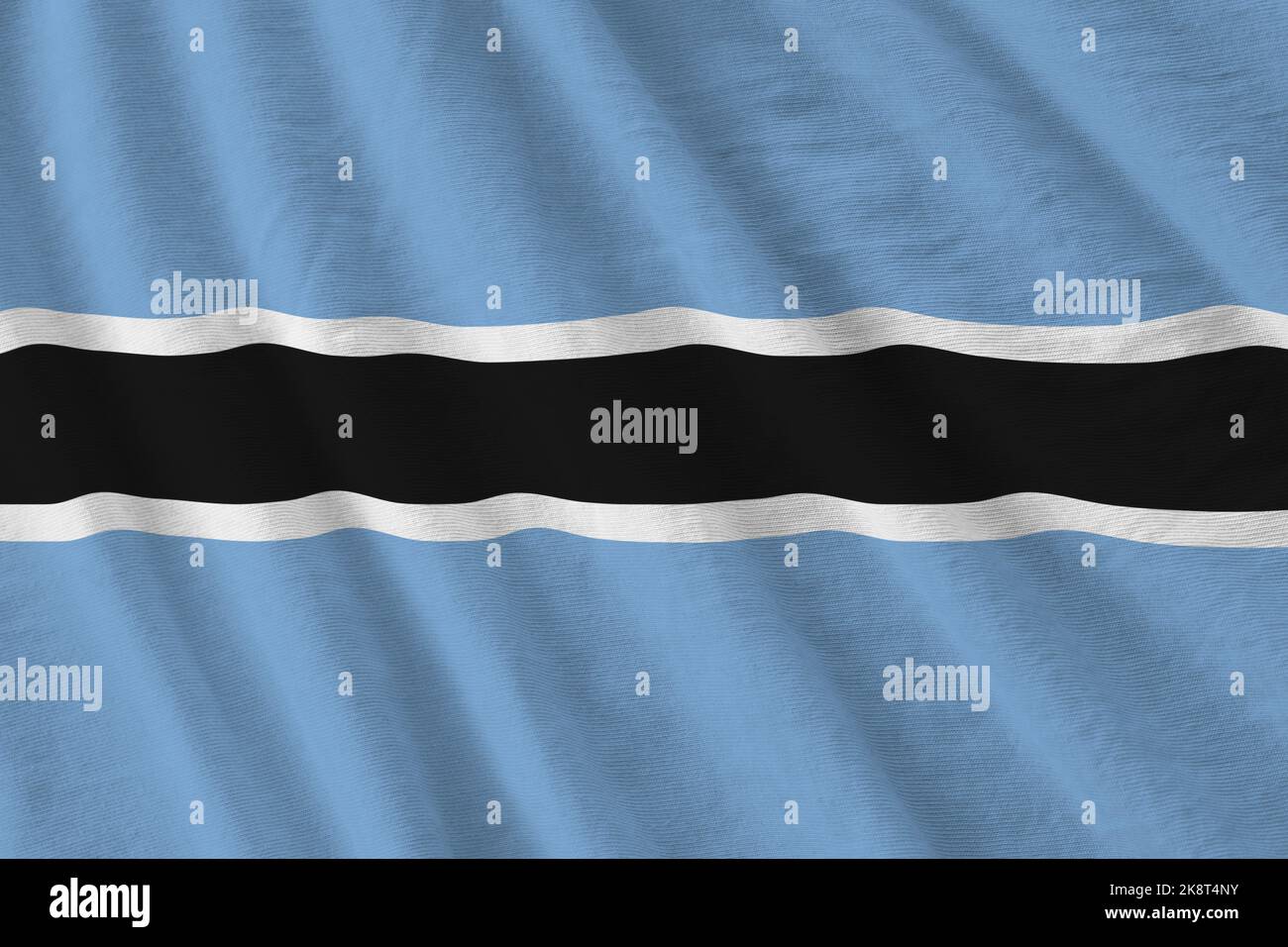 Botswana flag with big folds waving close up under the studio light ...