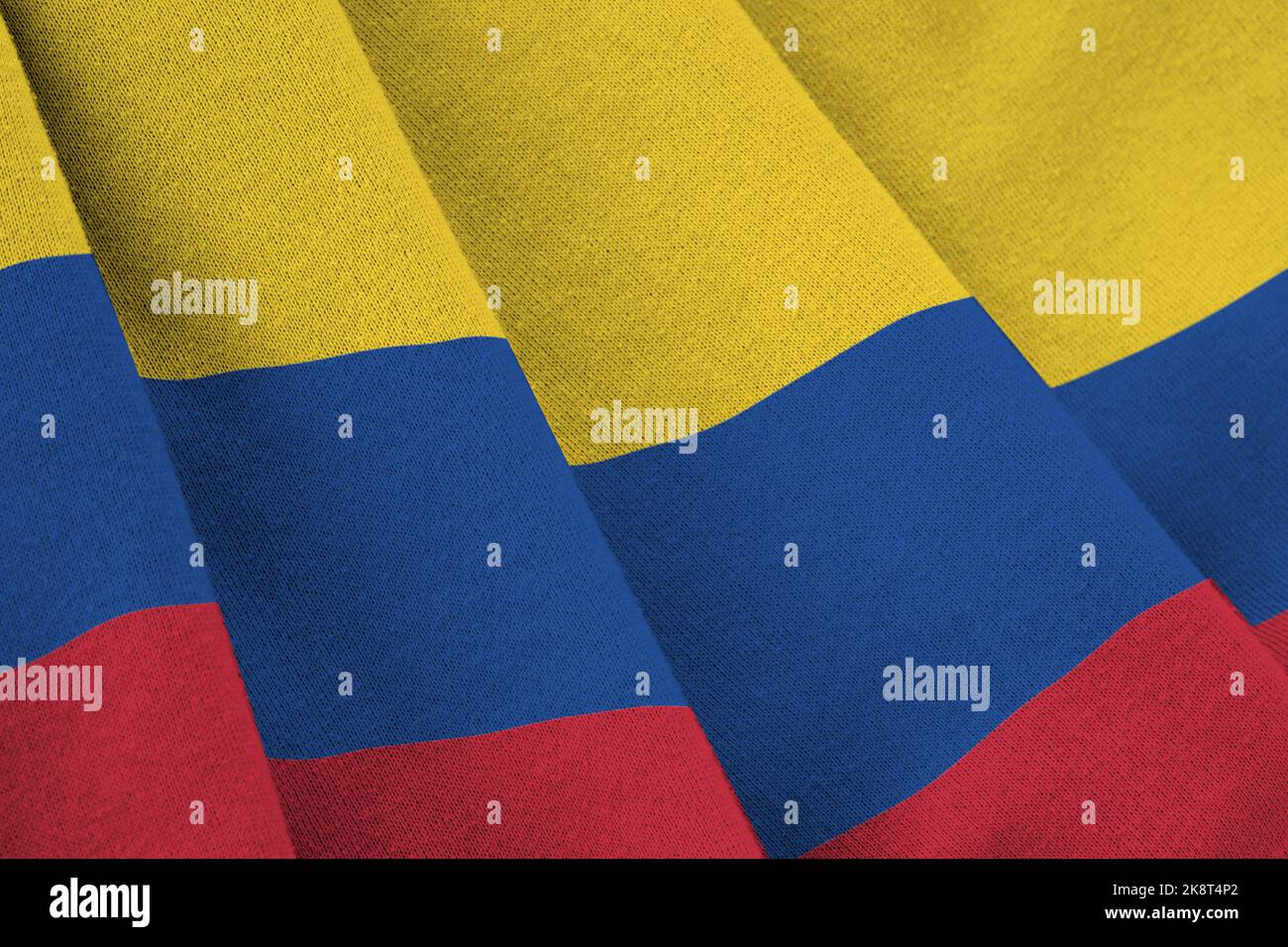 Colombia flag with big folds waving close up under the studio light ...