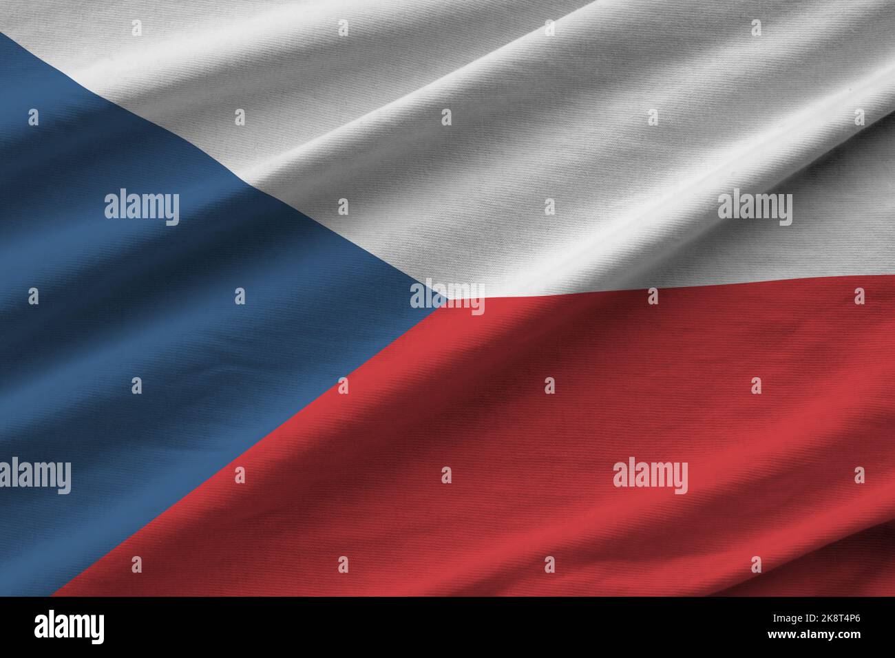 Czech flag with big folds waving close up under the studio light ...