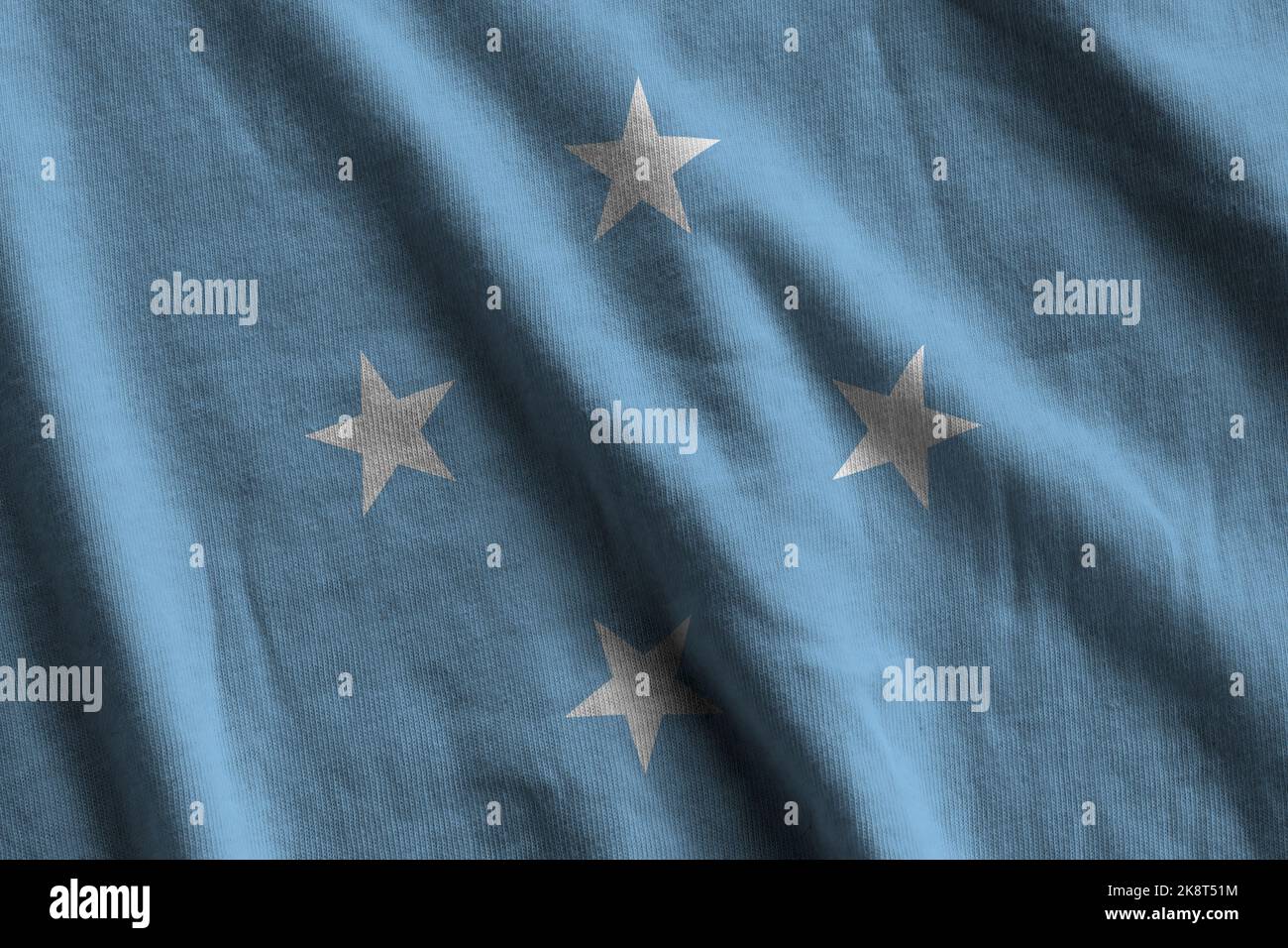 Micronesia flag with big folds waving close up under the studio light ...