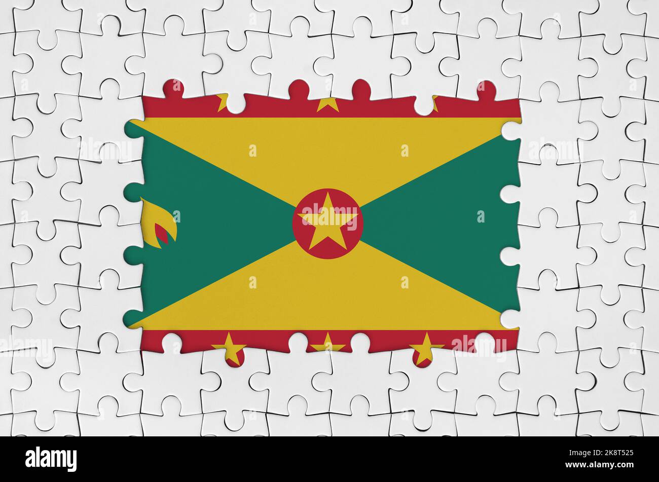 Grenada flag in frame of white puzzle pieces with missing central parts ...