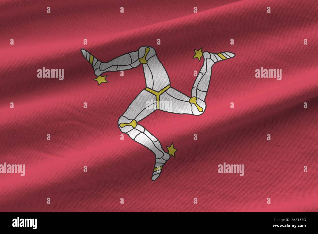 Isle of Man flag with big folds waving close up under the studio light ...