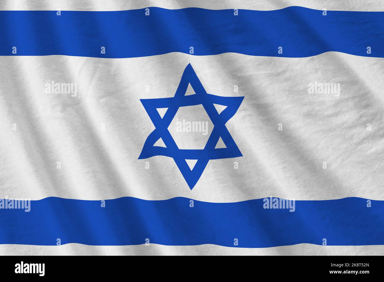 Israel flag with big folds waving close up under the studio light ...