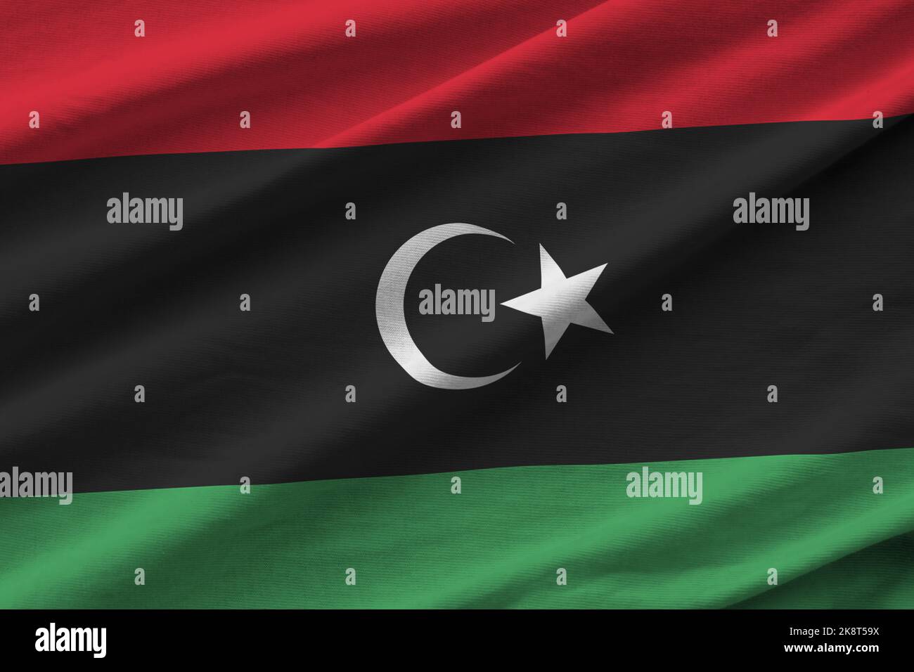Libya flag with big folds waving close up under the studio light ...