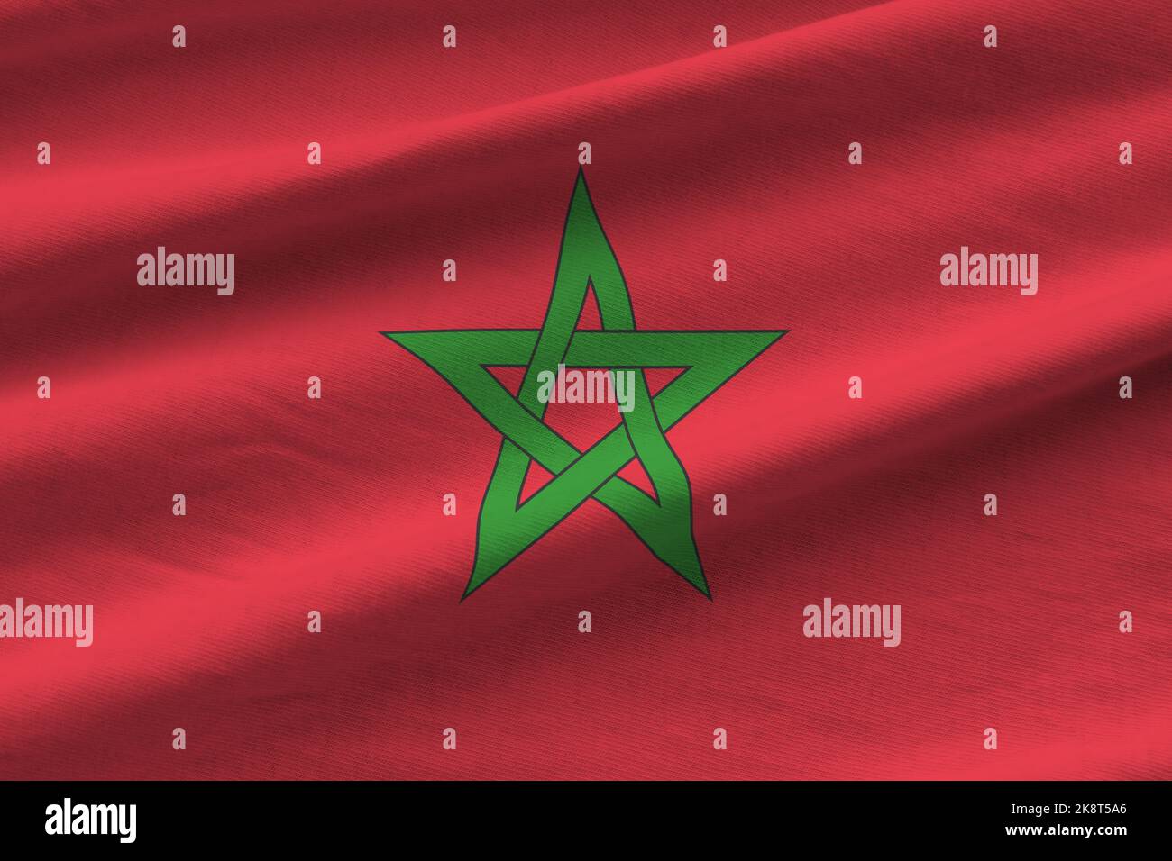Morocco flag with big folds waving close up under the studio light ...
