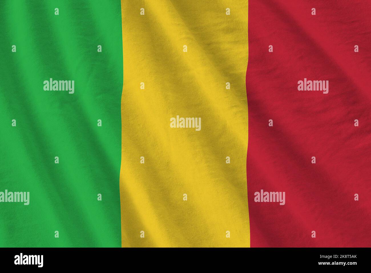 Mali flag with big folds waving close up under the studio light indoors ...