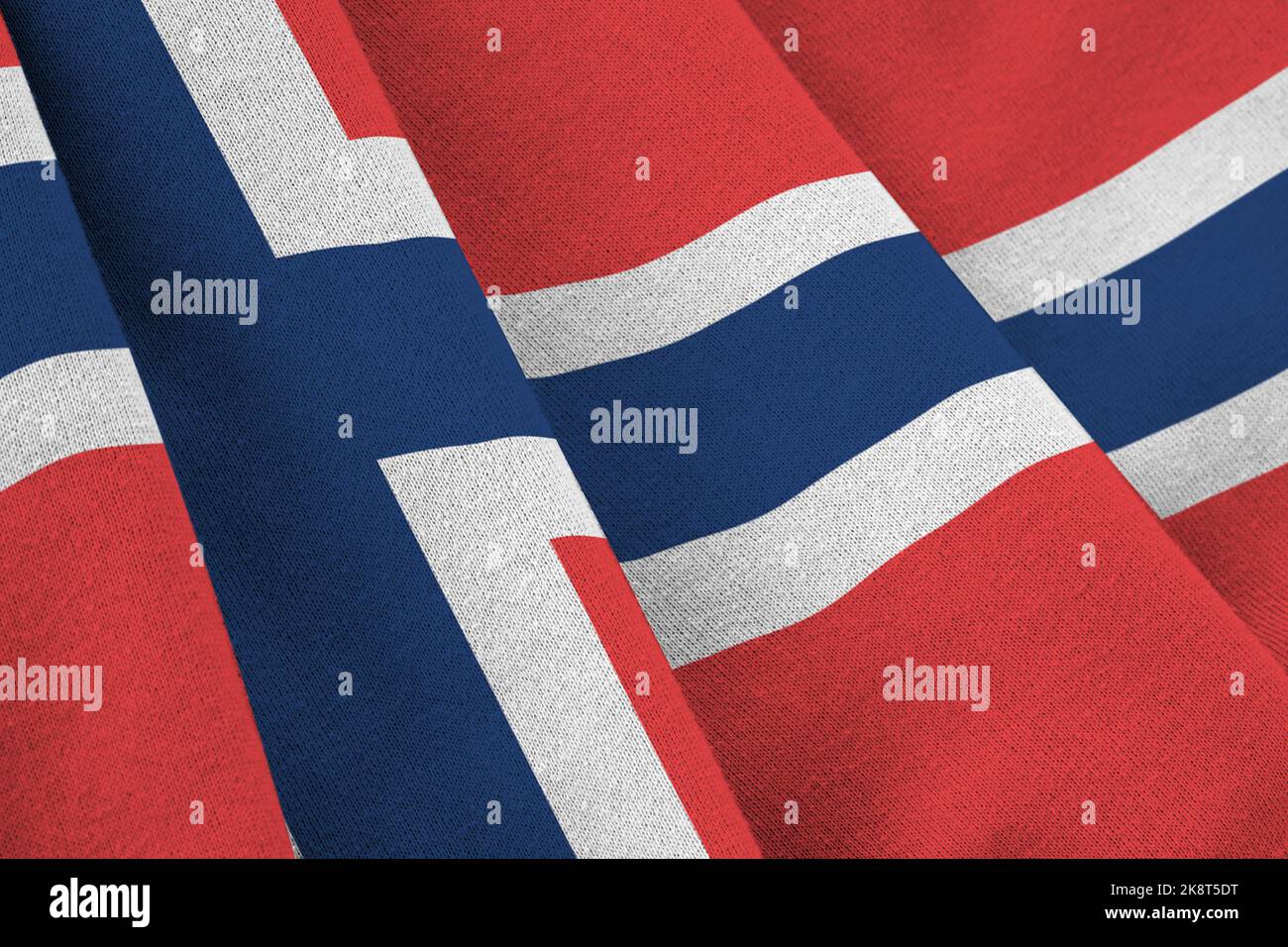 Norway flag with big folds waving close up under the studio light ...