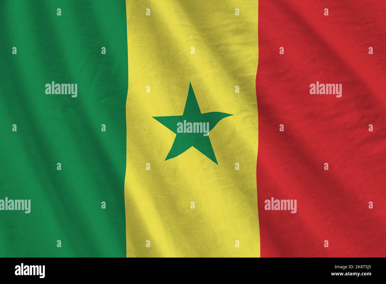 Senegal flag with big folds waving close up under the studio light ...