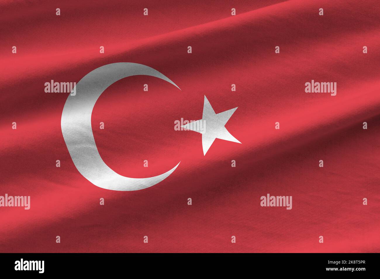 Turkey flag with big folds waving close up under the studio light ...