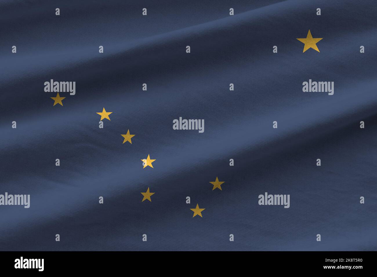 Alaska US state flag with big folds waving close up under the studio ...
