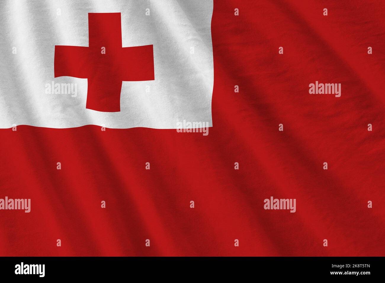 Tonga flag with big folds waving close up under the studio light ...