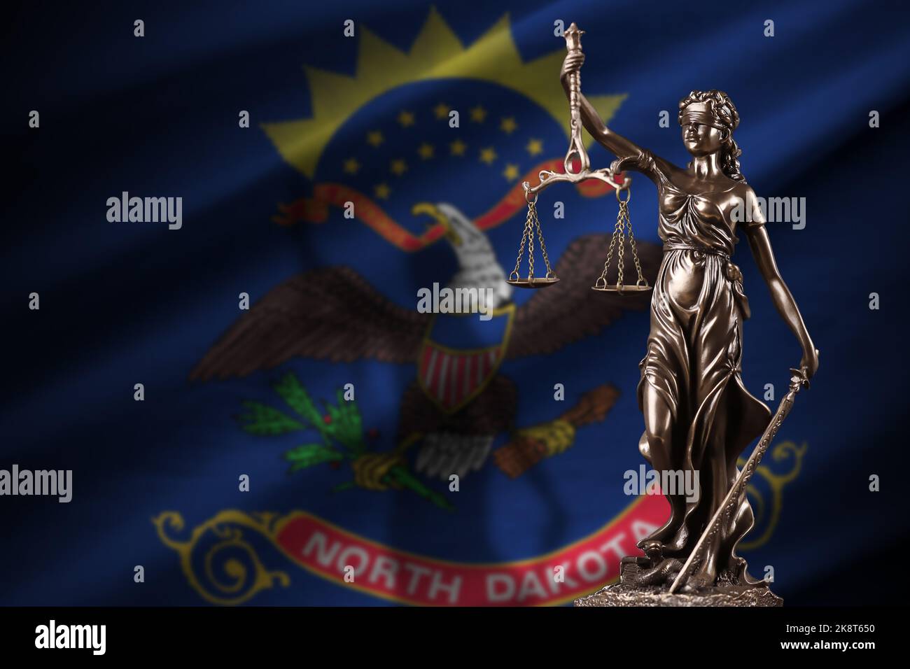 North Dakota US state flag with statue of lady justice and judicial ...