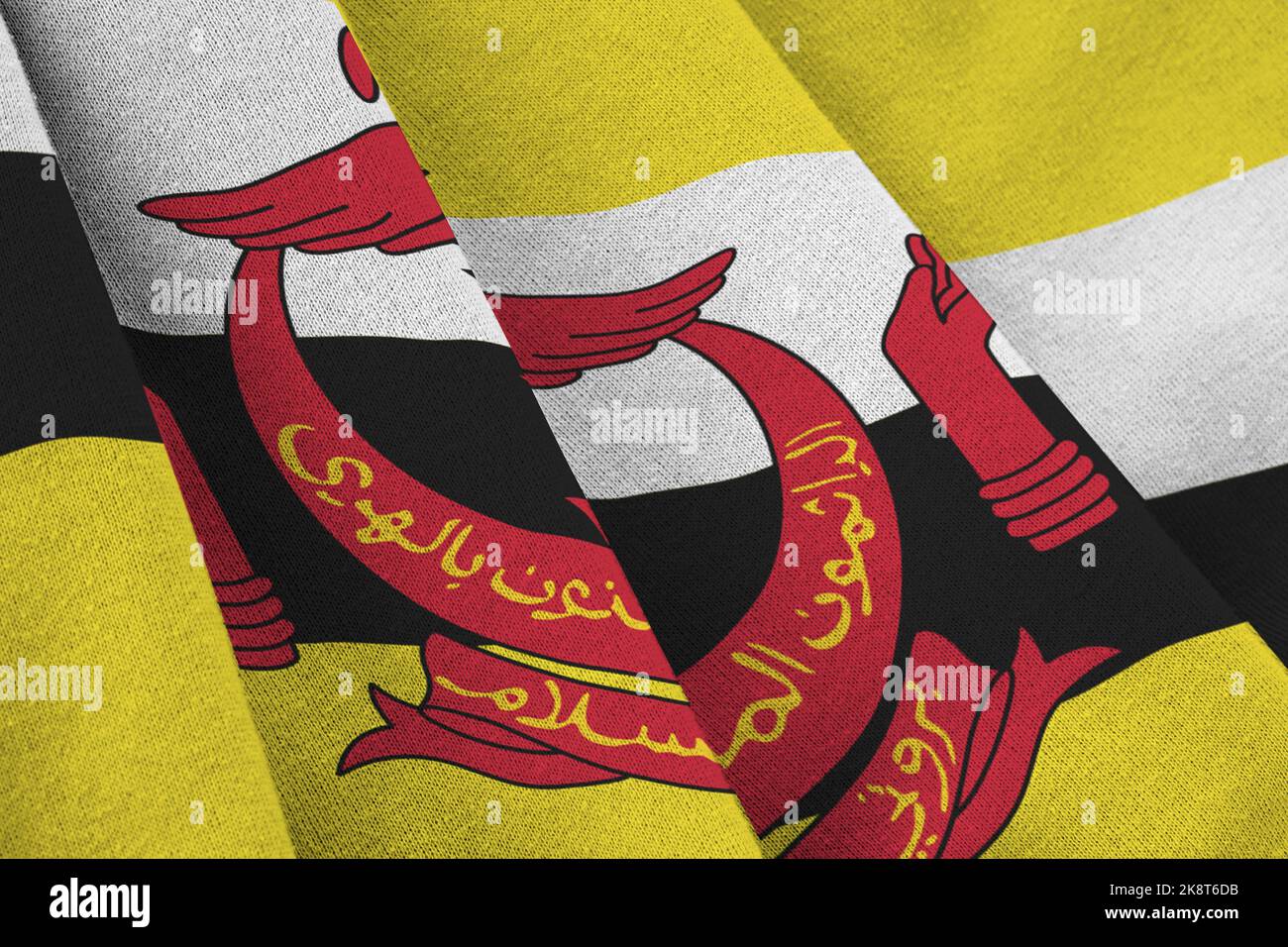 Brunei Darussalam flag with big folds waving close up under the studio ...